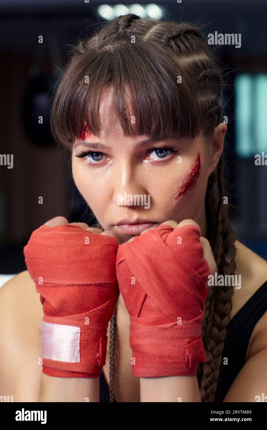 Female fighter with boxing taping; bandage on her hands stands Stock ...