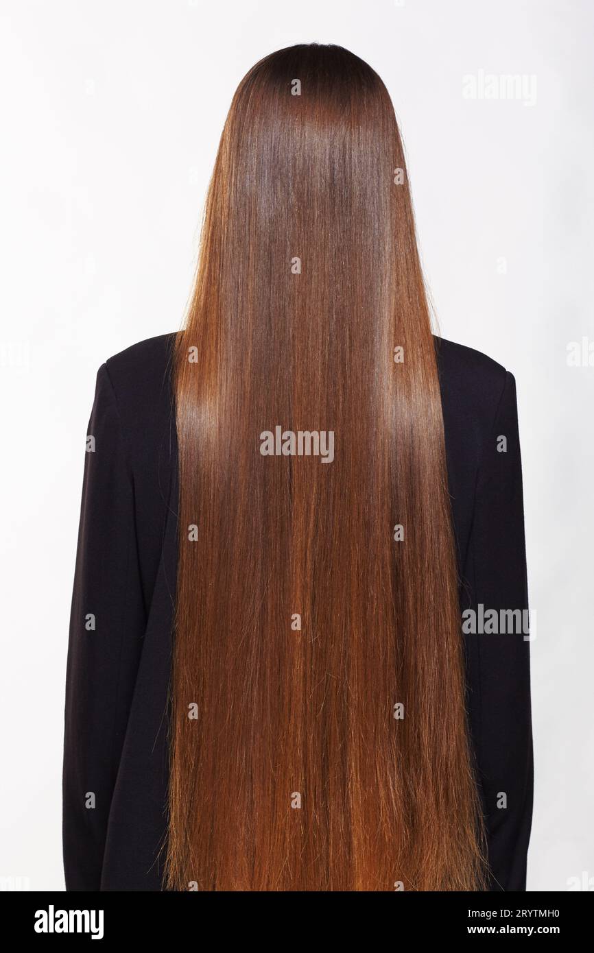 A woman from the back with very long brown hair Stock Photo - Alamy