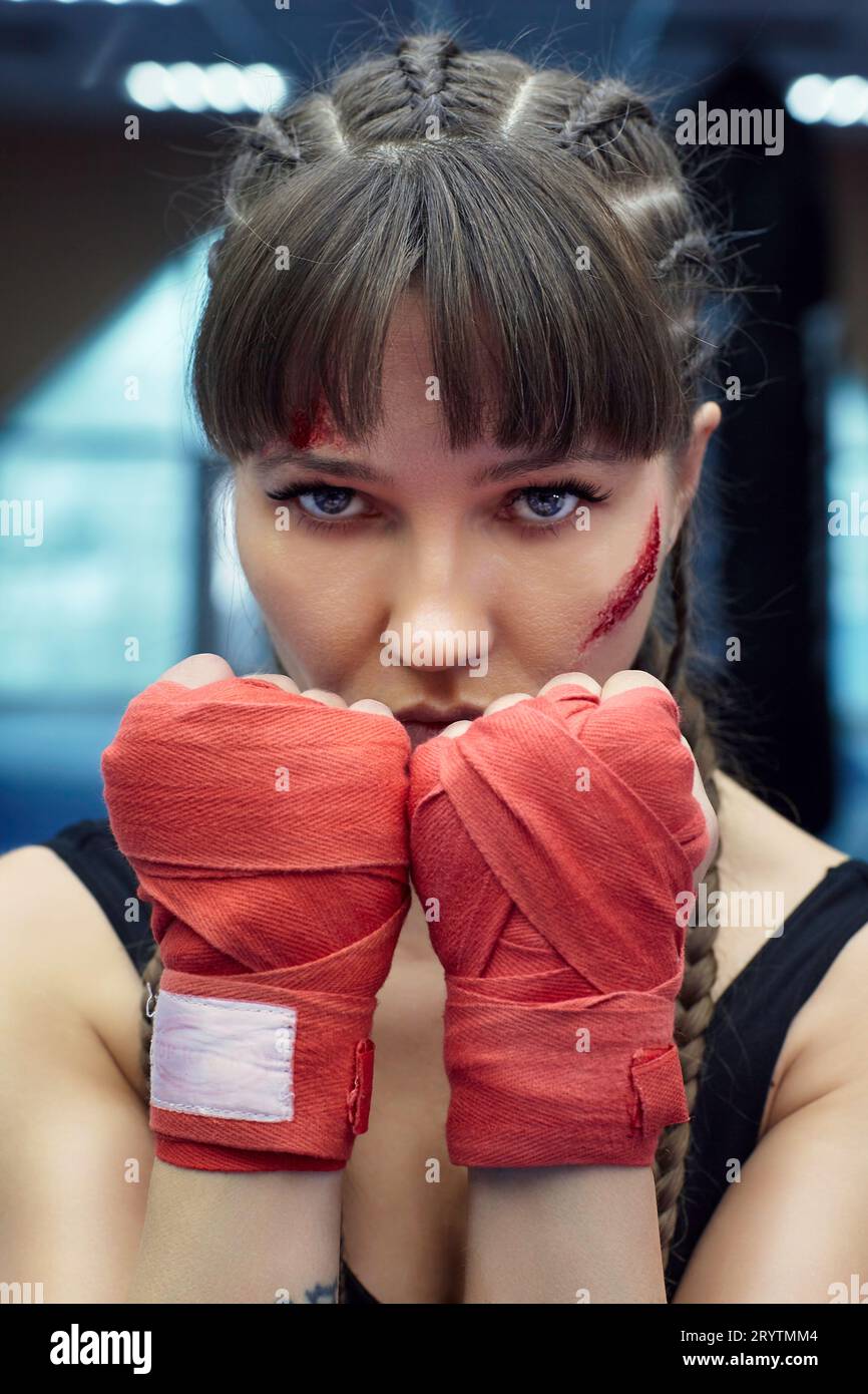 Female fighter with boxing taping; bandage on her hands stands Stock ...