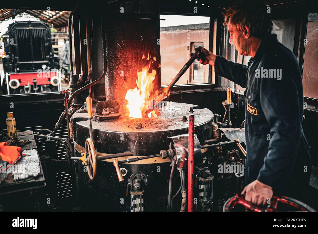 Firing up the steam train, inside the engine housing, at the Cholsey and Wallingford Railway ...