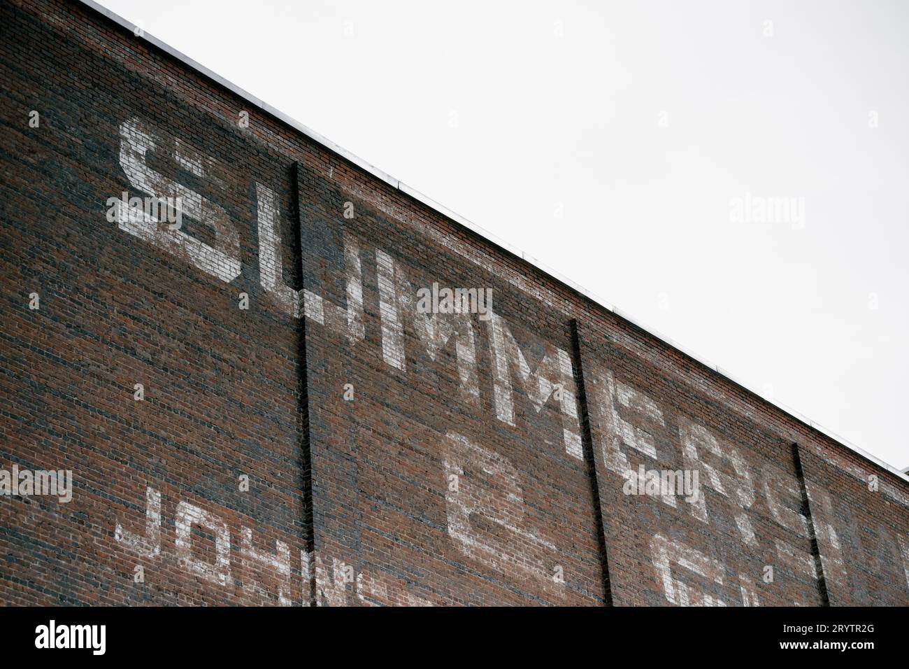 A distressed metal building with vintage lettering, with a weathered ...