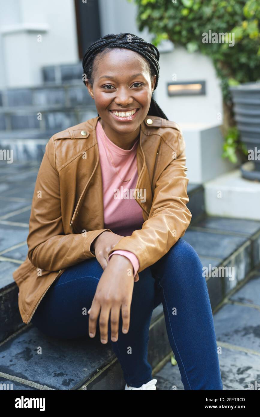 Woman sitting of stairs outside hi-res stock photography and images - Alamy