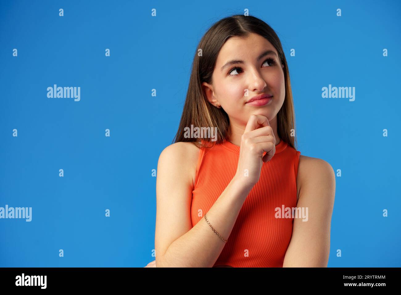 Young teen girl thinking about something over blue background Stock ...