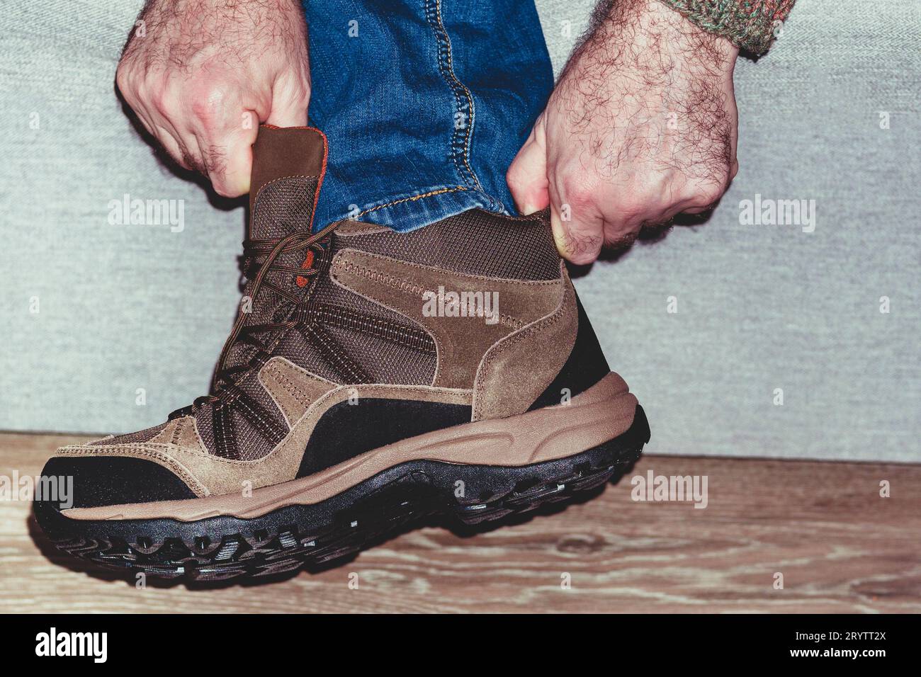Shoe fitting. A man put on shoes new shoes. Male hands holding a boot ...