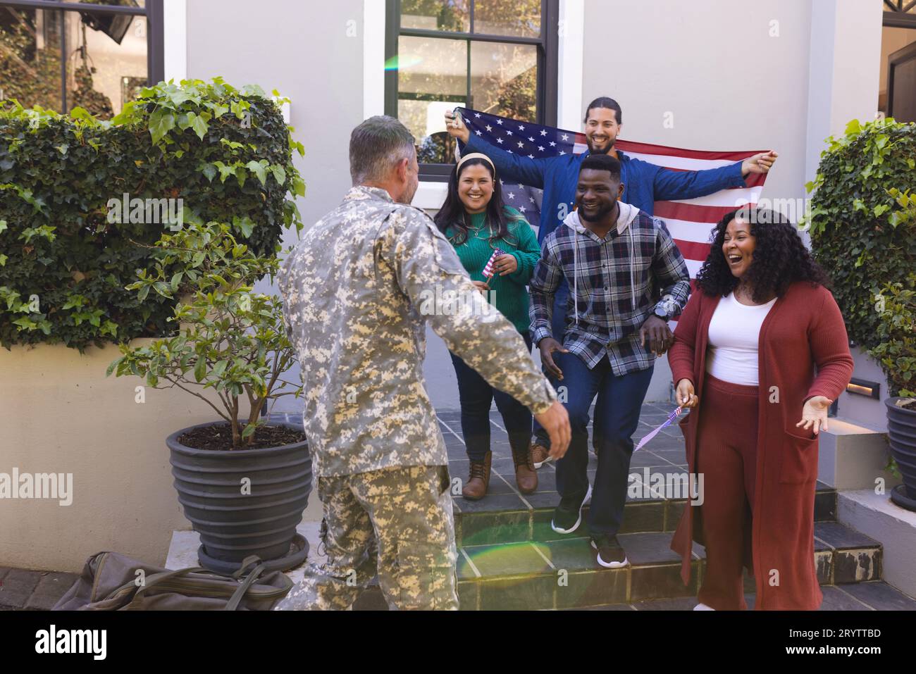 Happy diverse friends with flags welcoming home male soldier friend ...