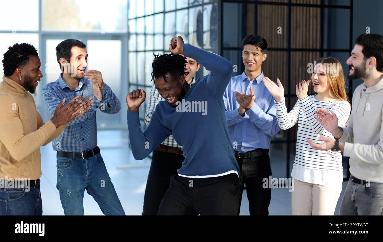 happy excited millennial employees shouting for joy, raising hands for ...