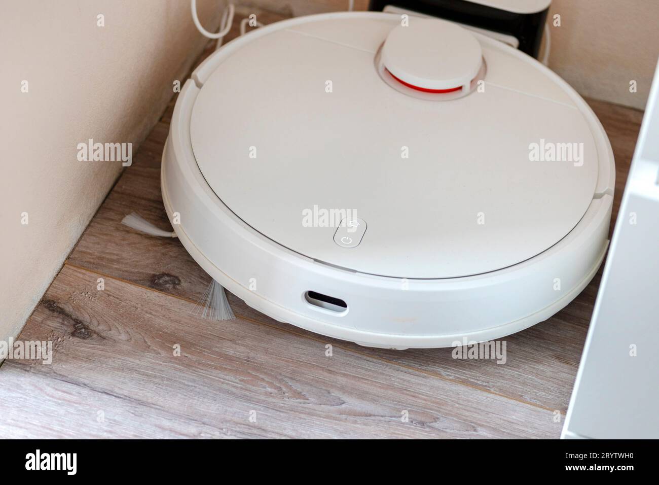 White robot vacuum cleaner. robotic exhauster is charging energy. top ...