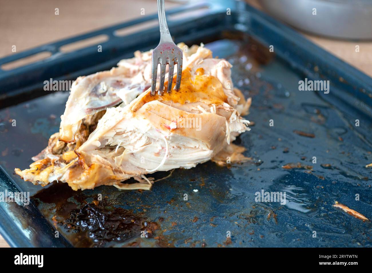 Leftover food on the baking sheet. Gnawed chicken carcass. Tasty dish ...