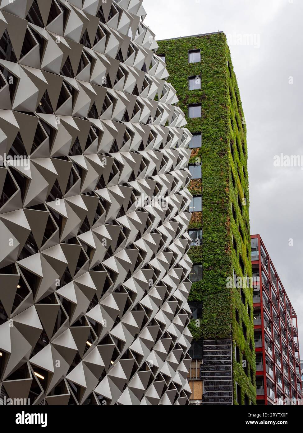 Modern new build office block with plants growing vertically on the ...
