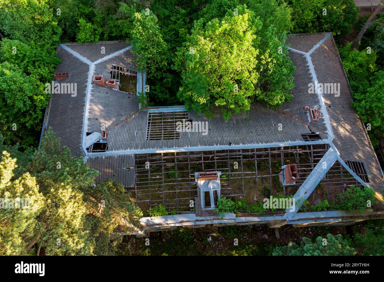 Aerial view of the leaky roof of an abandoned decaying building in a ...