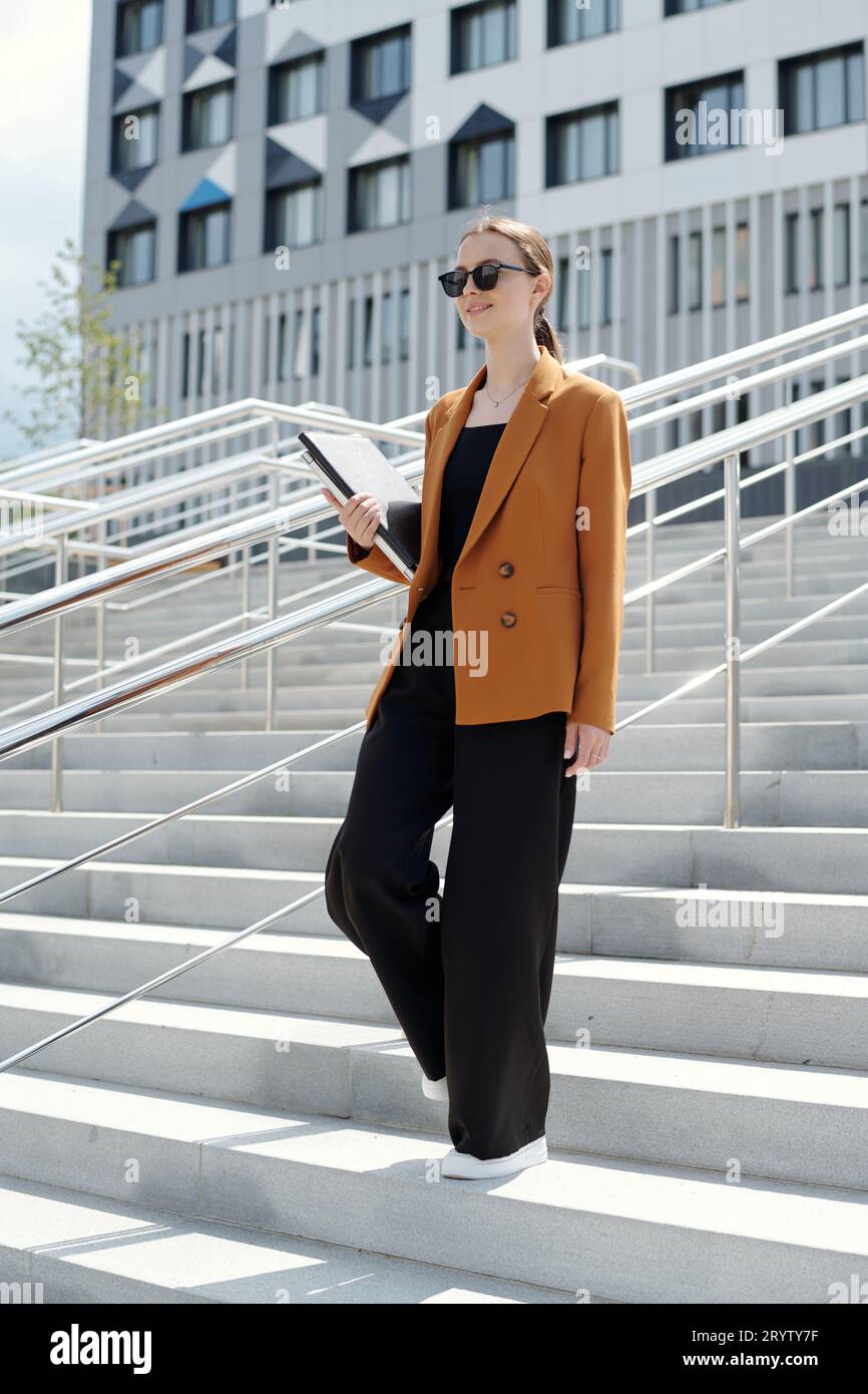 Young successful self employed female entrepreneur with documents ...