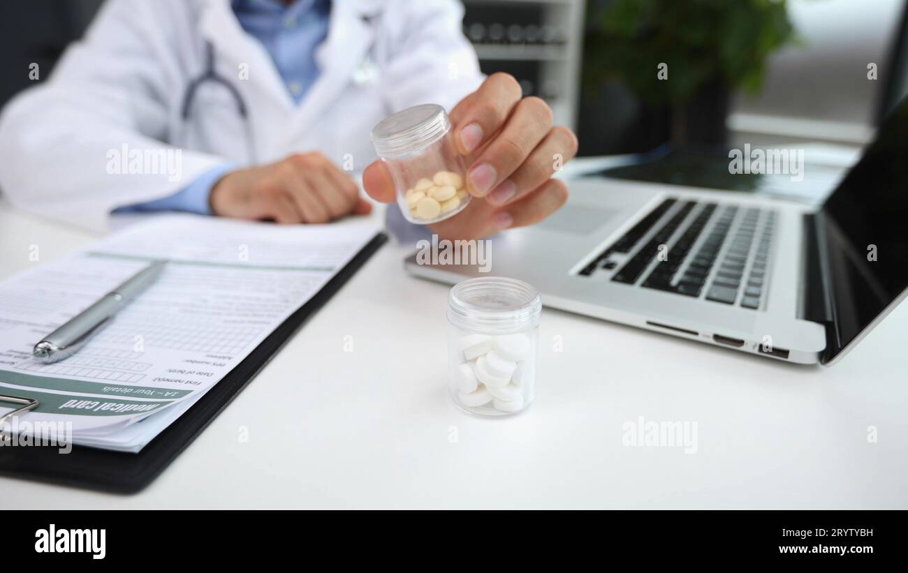 The doctor writes a prescription holding pills in his hand Stock Photo ...