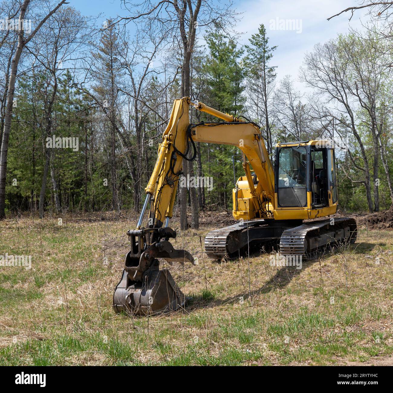 Yellow excavator or digger machine, is used in preparation of a ...