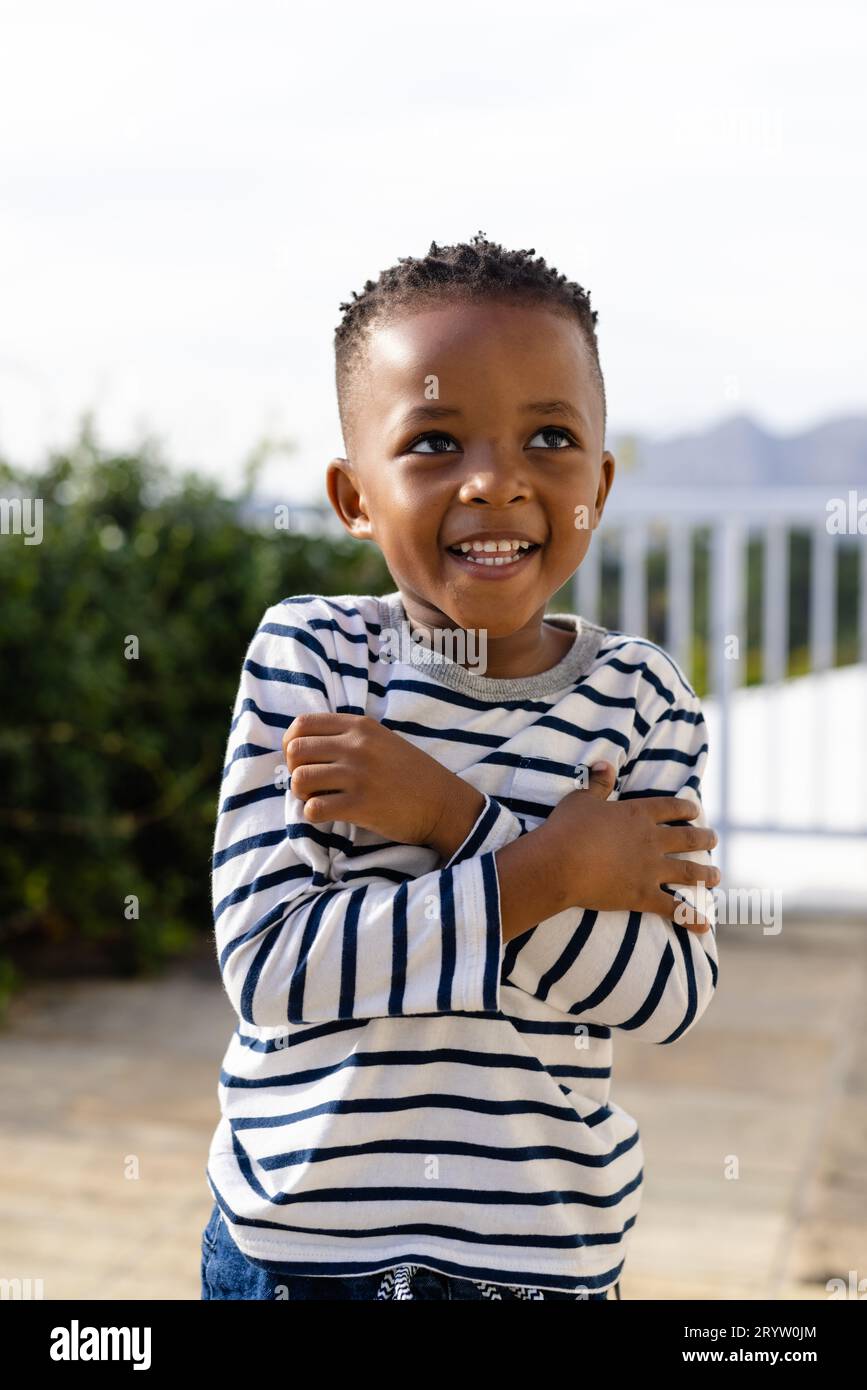 Portrait of happy african american boy staying on sunny terrace Stock ...