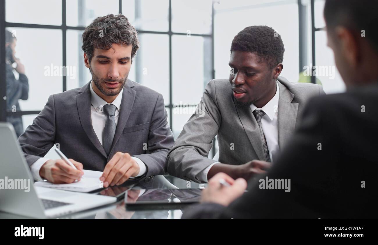 Working on their group project. Cropped shot of three business people ...