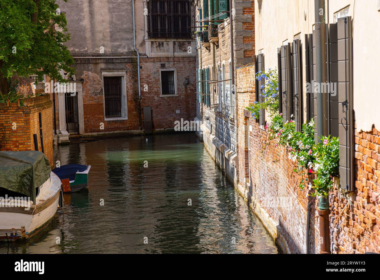 A scenic view of a winding canal with buildings on both sides Stock ...