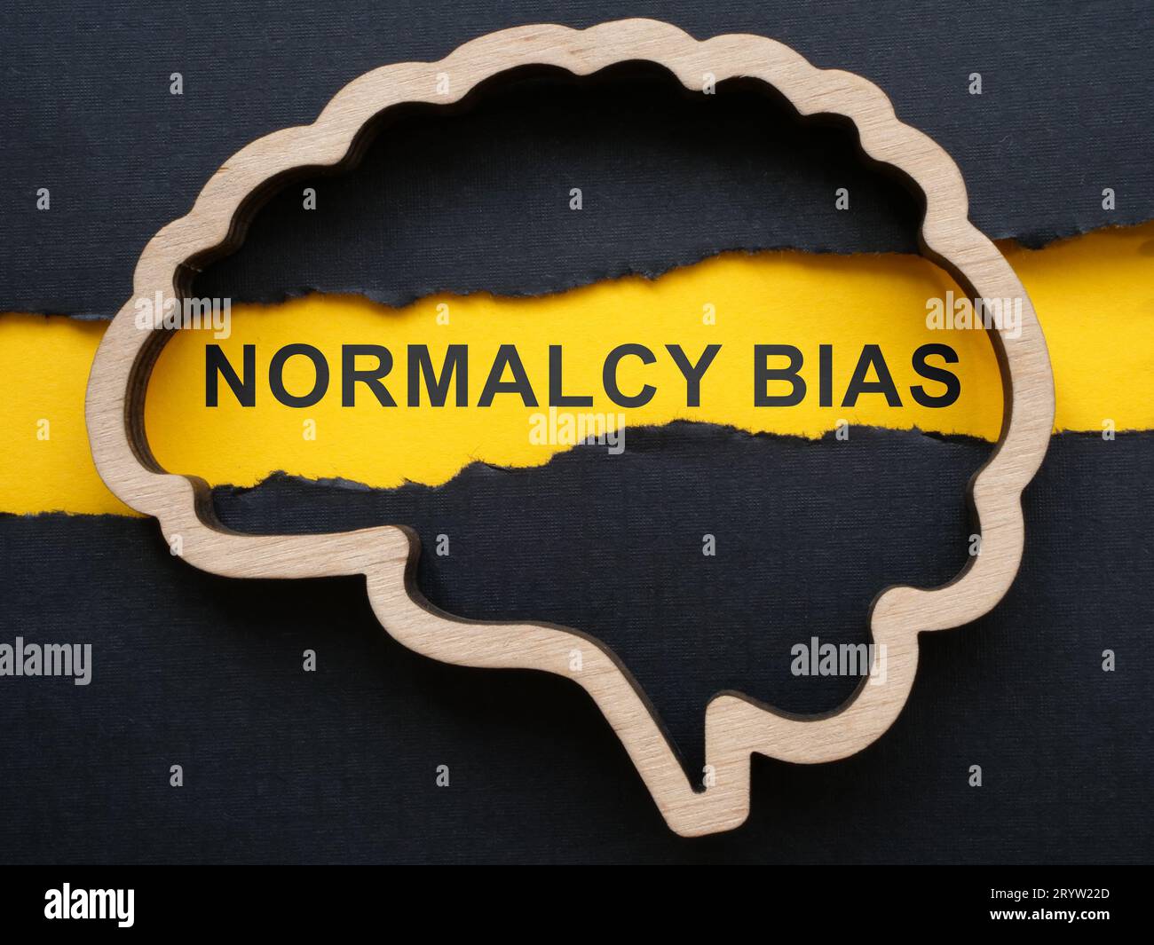 Brain outline, torn paper and sign normalcy bias Stock Photo - Alamy