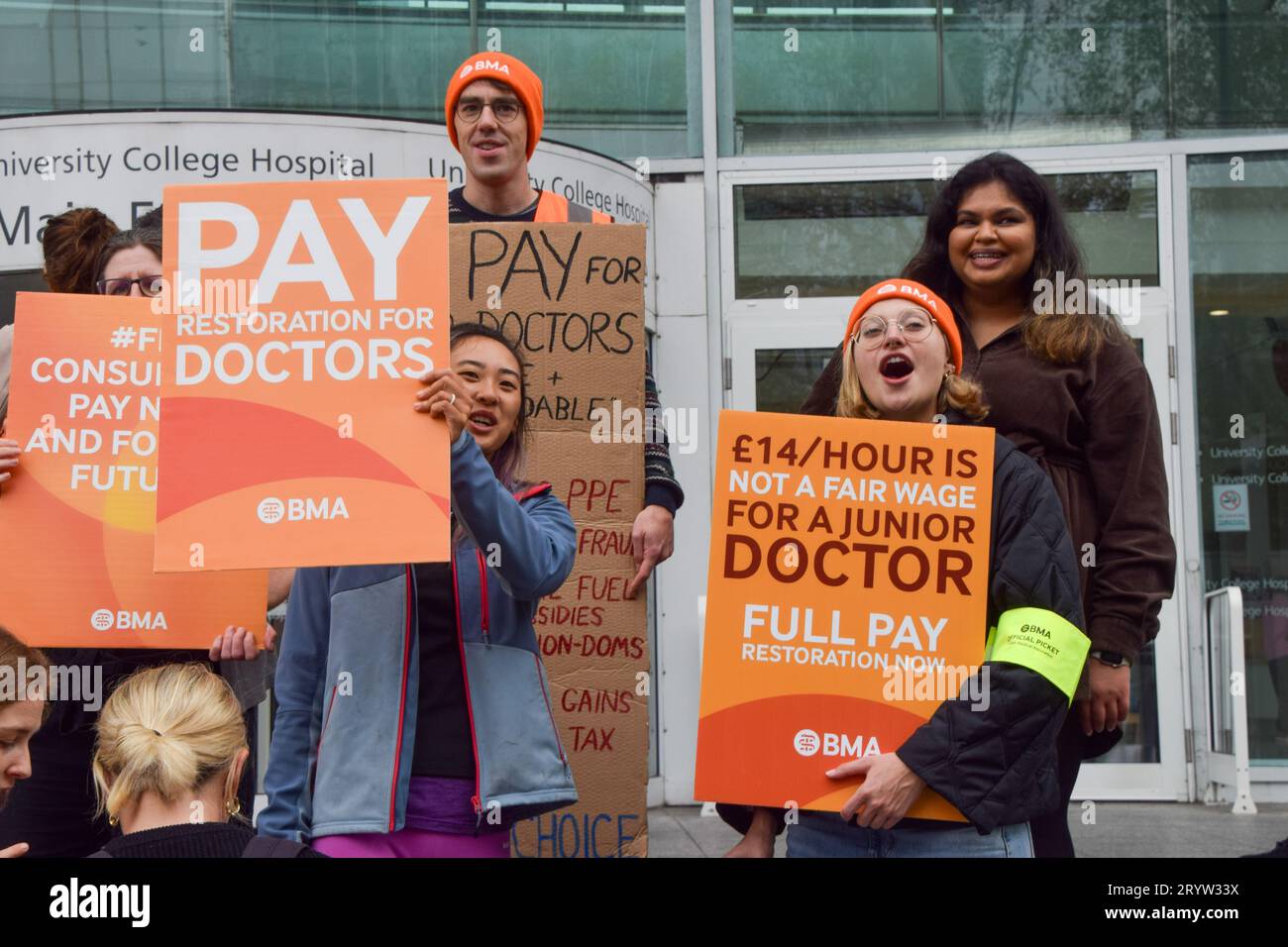 Doctors stand with placards in support of fair pay at the British ...