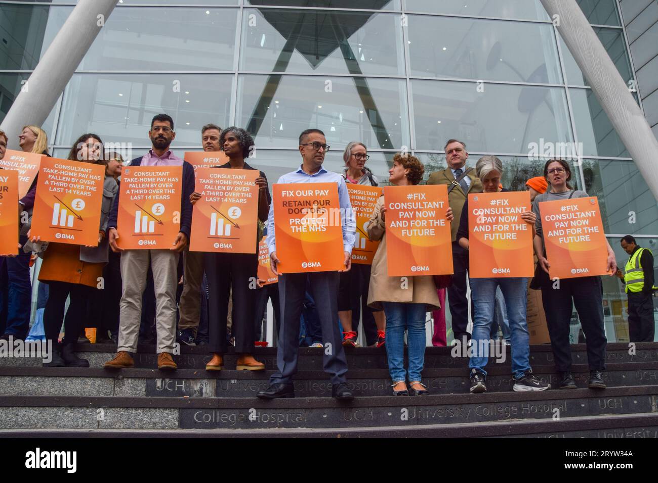 Doctors stand with placards in support of fair pay at the British ...