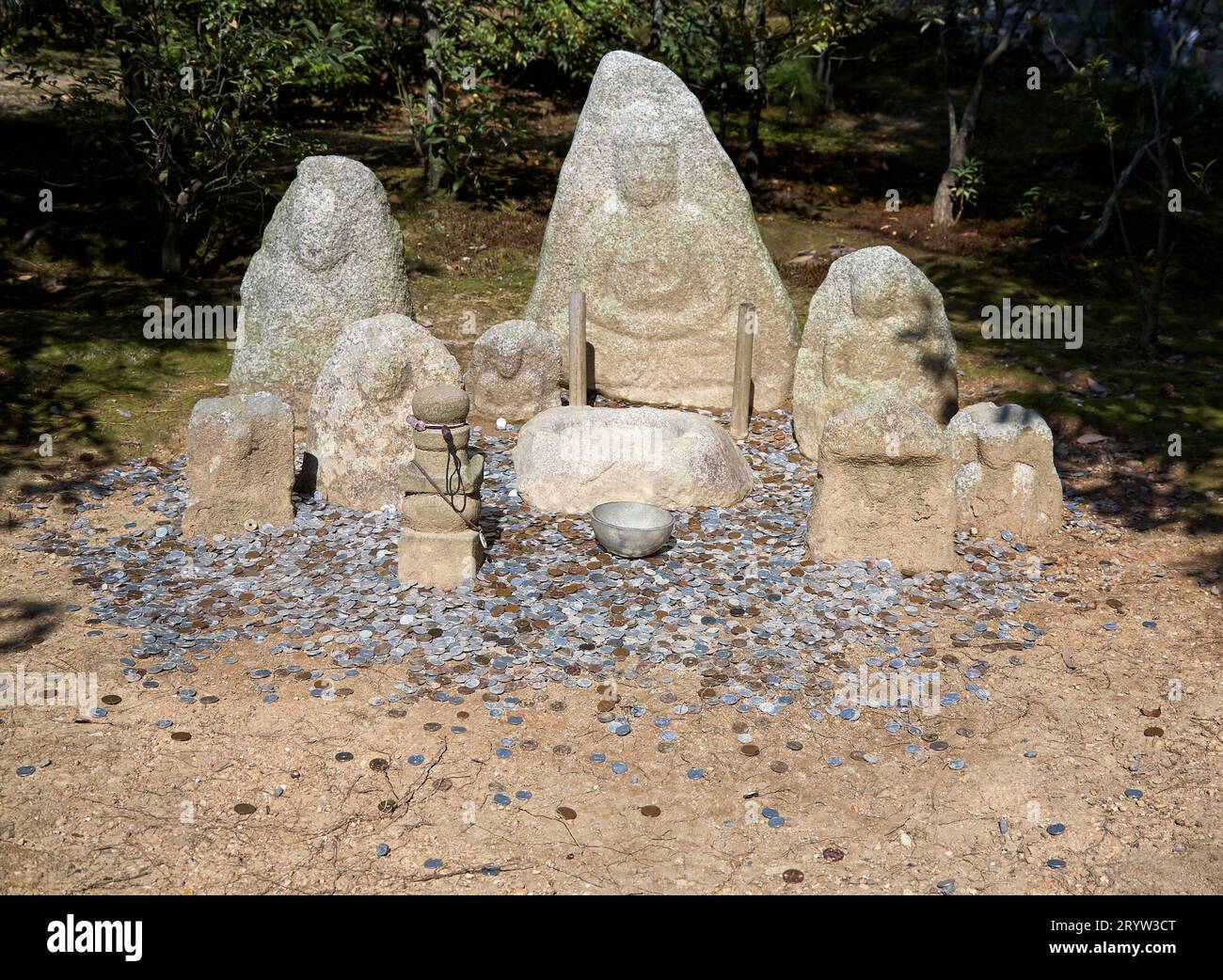 Jizo Buddhist images and coins that visitors tossed. Kinkaku-ji temple ...