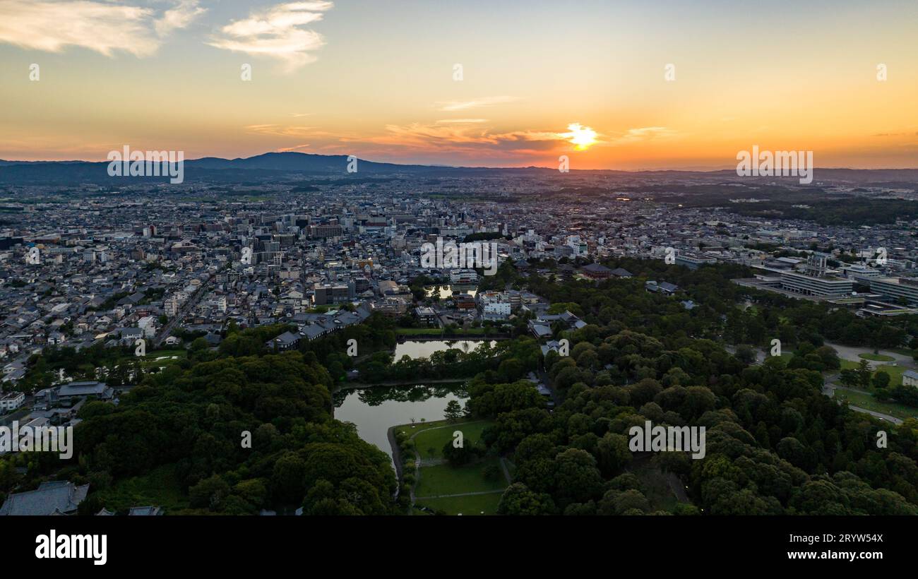 Aerial view of the cityscape of downtown Nara, sunny evening in Japan ...