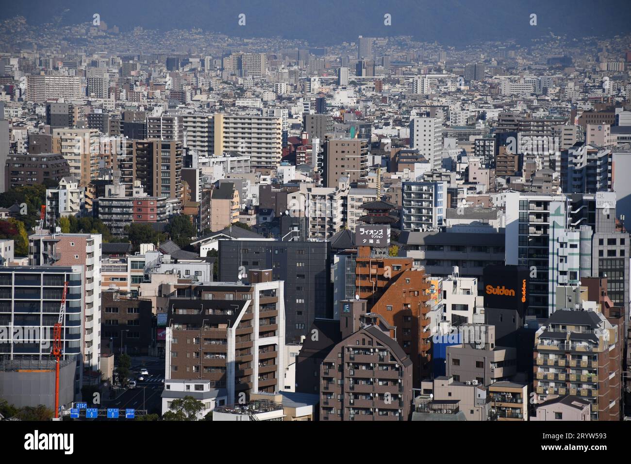 Aerial view of a bustling cityscape with numerous high-rise buildings, featuring a vibrant ...