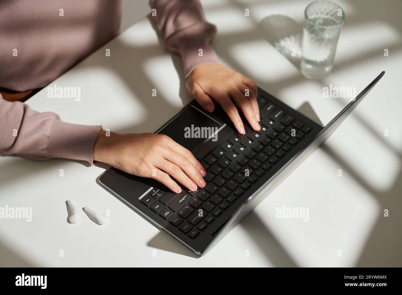 Above angle of hands of young female student or solopreneur pressing ...