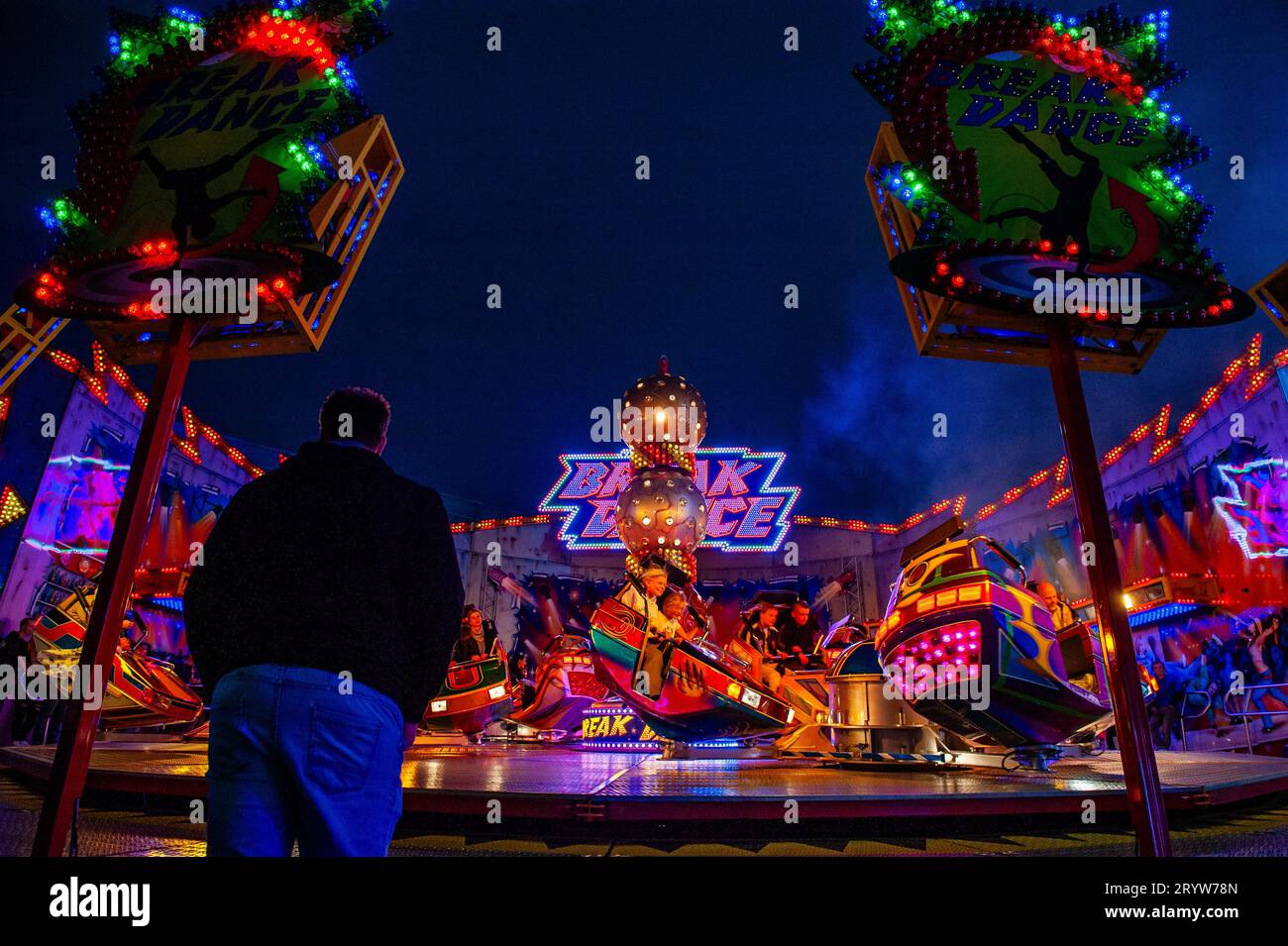 A man is seen watching people having fun in one of the attractions ...