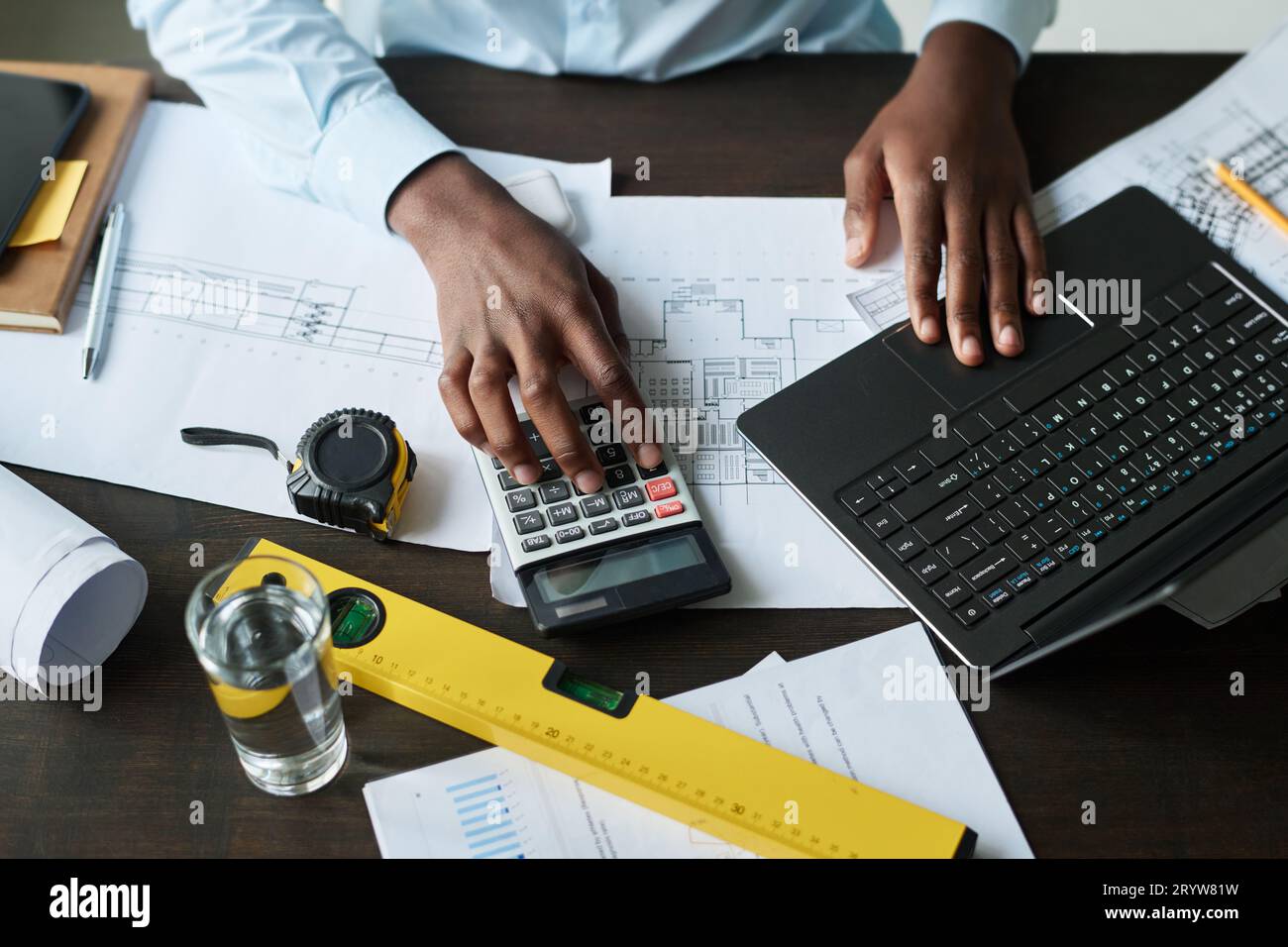 Above angle of hands of young African American male architect with ...