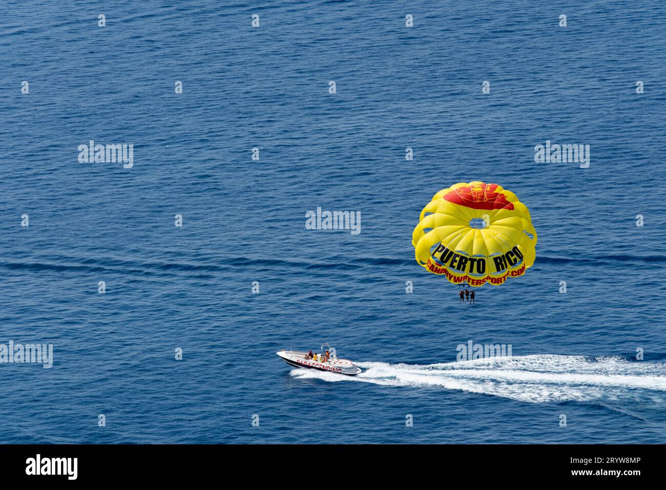 A couple enjoy a Paragliding boat activity during a holiday in Puerto ...