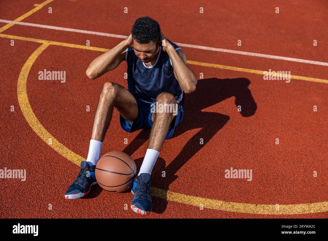 Black man doing sit ups and crunches exercising abdominal muscles ...