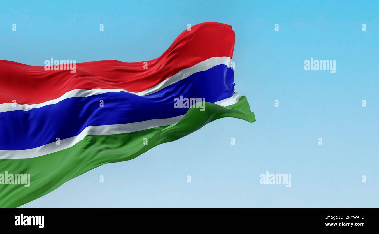 National flag of the Gambia waving in the wind on a clear day. Three ... National flag of the Gambia waving in the wind on a clear day. Three ...