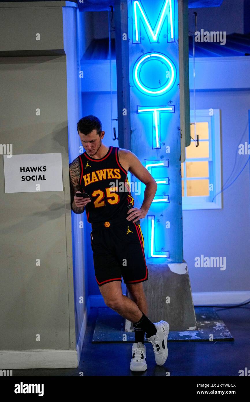 Atlanta Hawks guard Garrison Mathews views his phone during media day ...