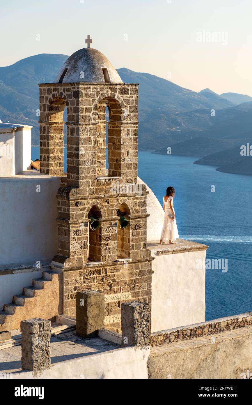 Woman in white dress looking at the sea in church Panagia Thalassitra ...
