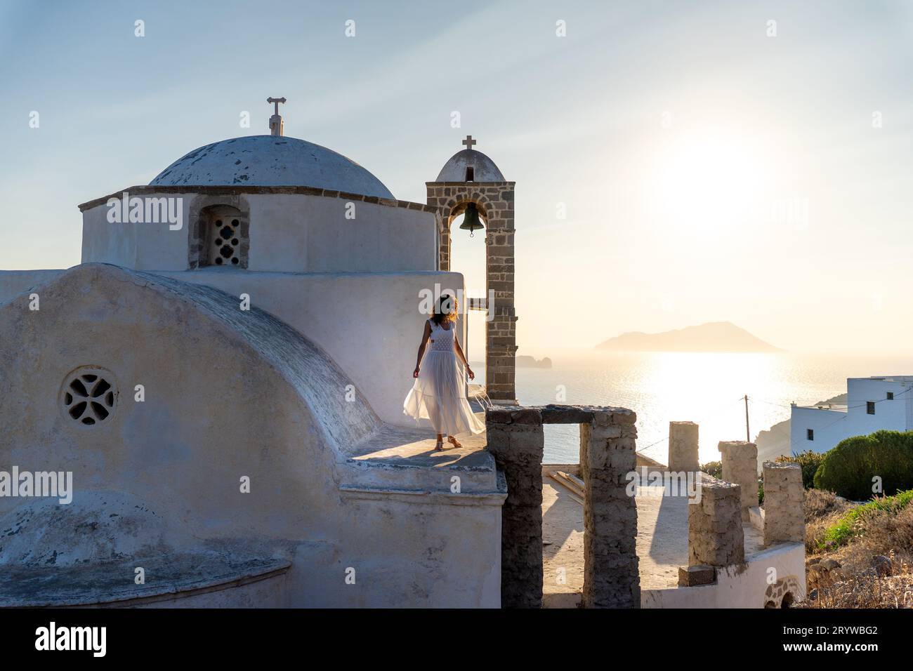 Woman in white dress looking at the sea in church Panagia Thalassitra ...