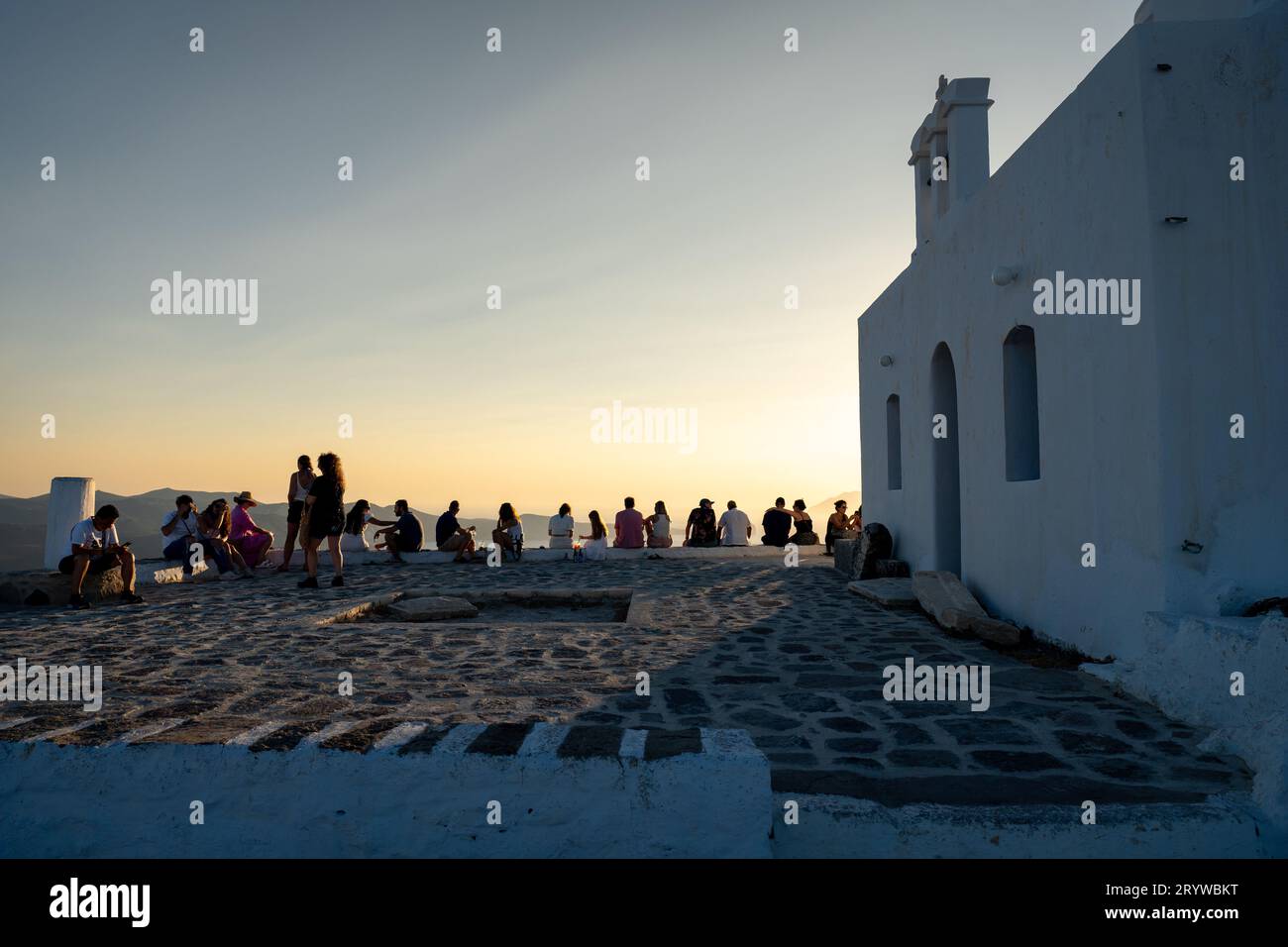 Unknown people watching sunset in Plaka, Milos Stock Photo - Alamy