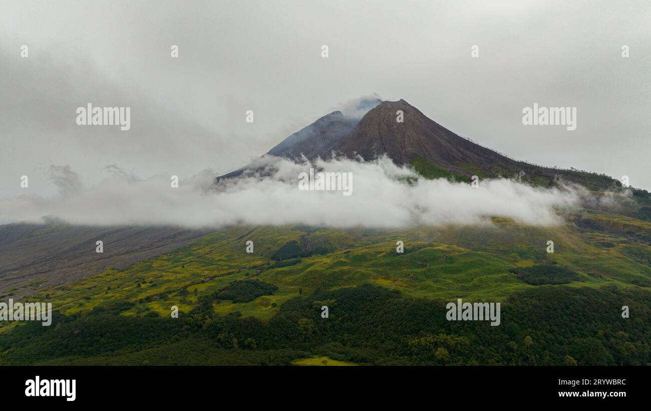 Aerial view of active volcano Sinabung with clouds and smoke. Sumatra ...