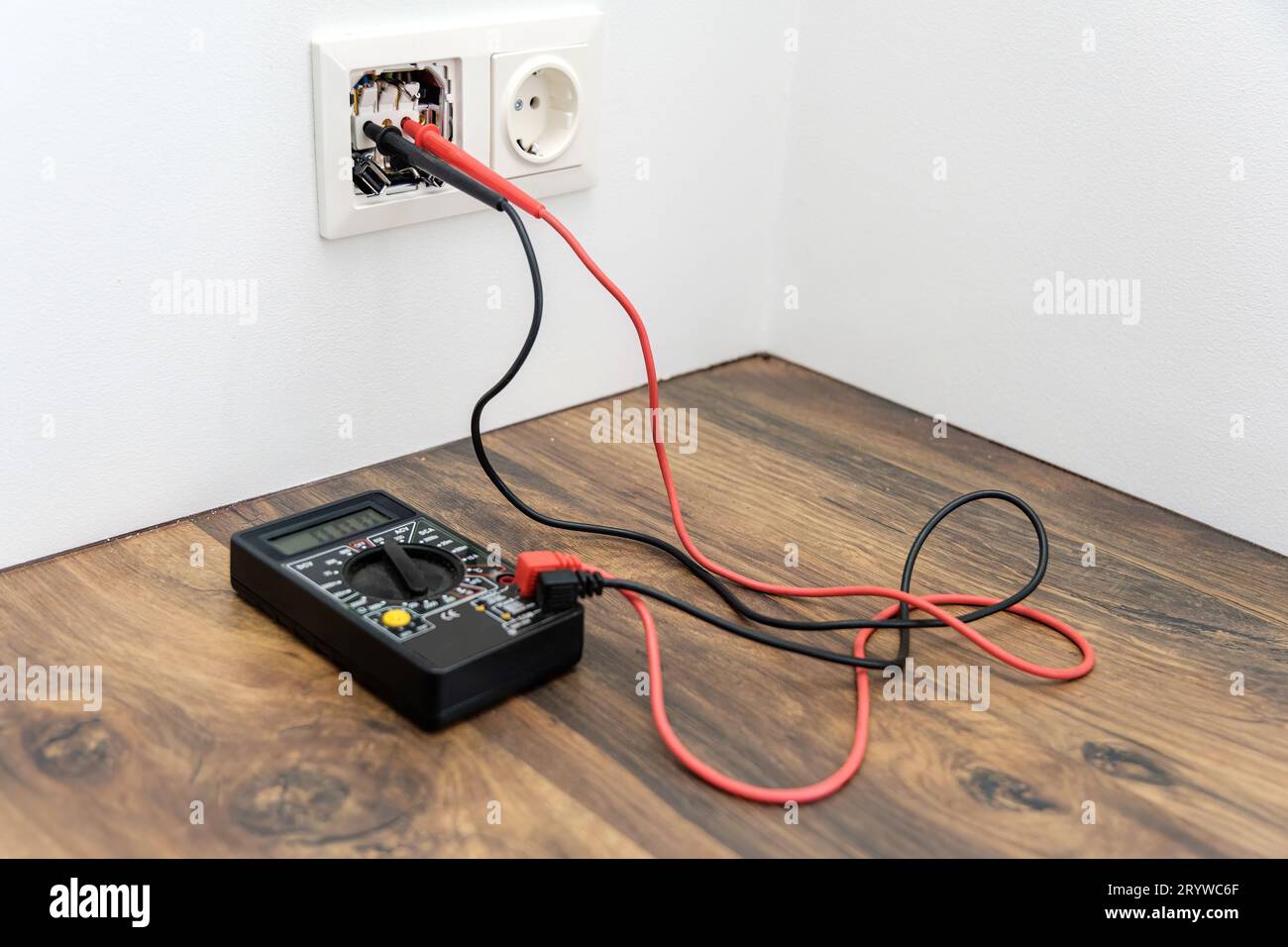 a pair of wire probes are plugged into the socket. Multimeter for measuring voltage Stock Photo ...