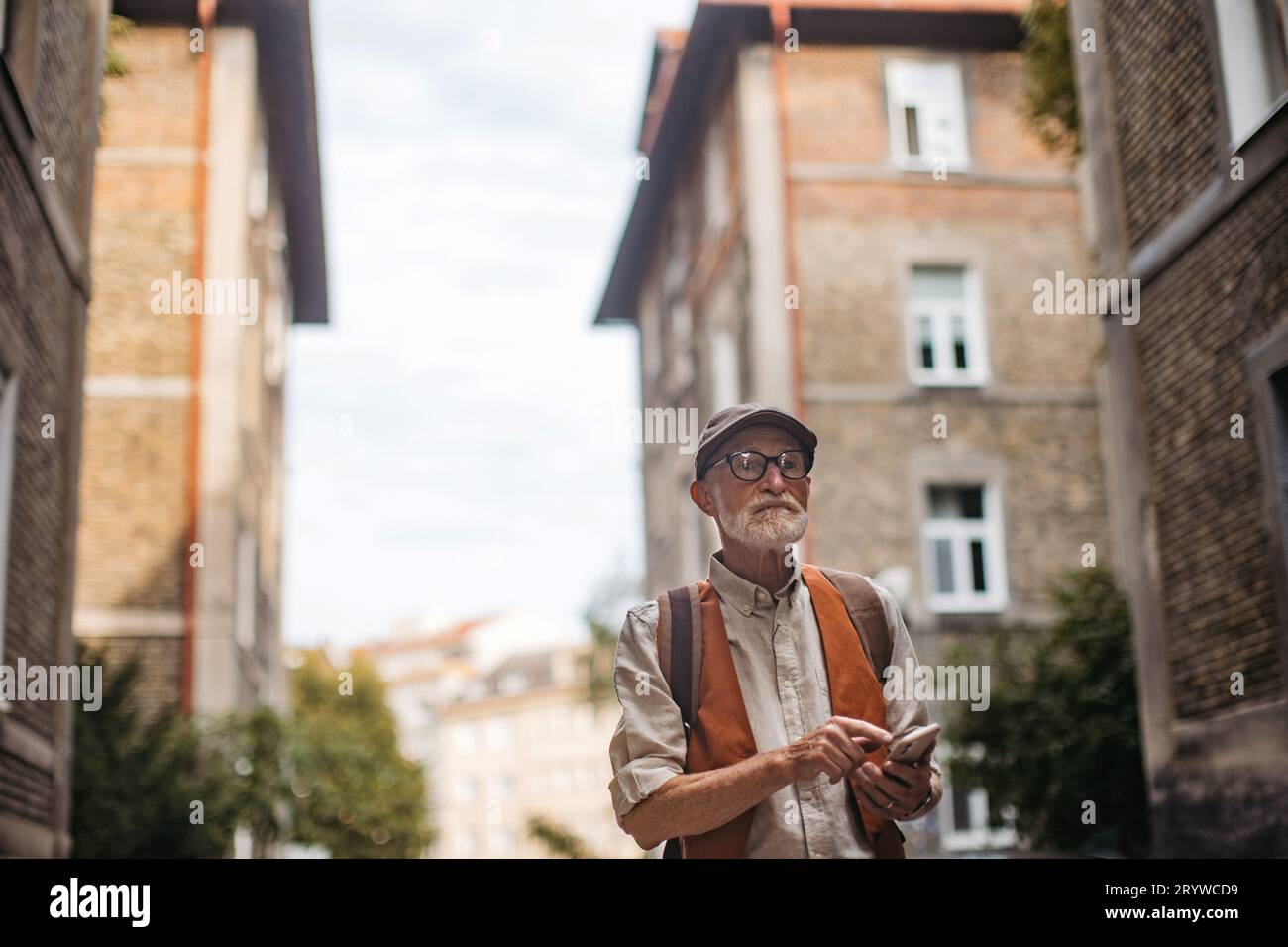 Senior tourist exploring a new city and visiting interesting sites ...