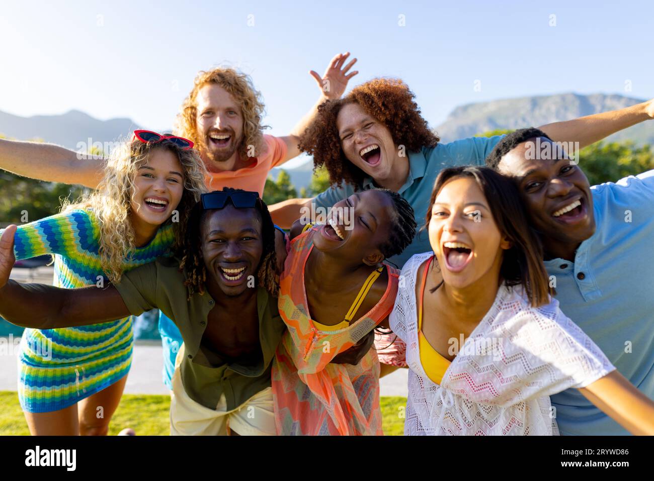 Portrait of happy diverse group of friends having party, smiling in ...