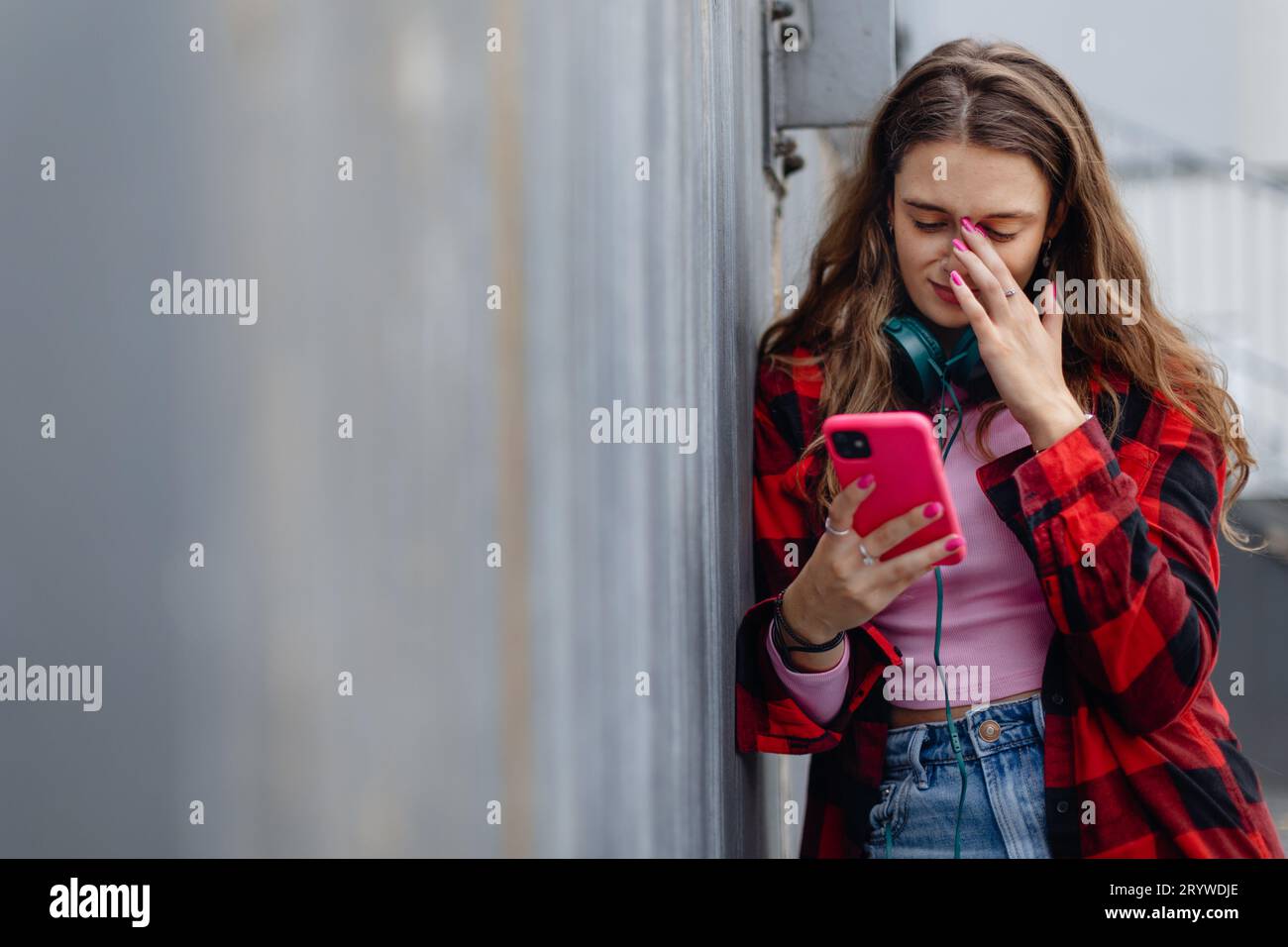 Gen Z girl outdoors in the city, feeling sad and anxious Stock Photo ...