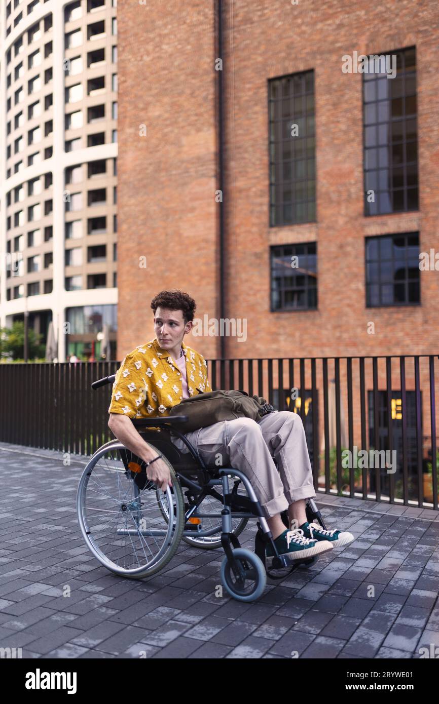 Gen Z boy in a wheelchair in the city Stock Photo - Alamy