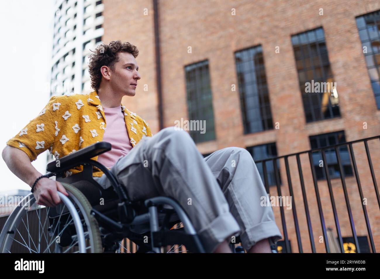 Gen Z boy in a wheelchair in the city Stock Photo - Alamy