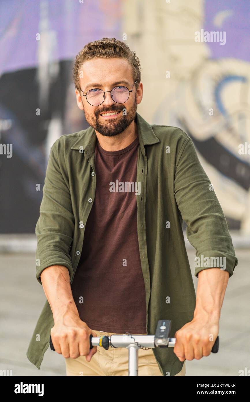 Man photographed outdoors, basking in natural sunlight. With confident ...