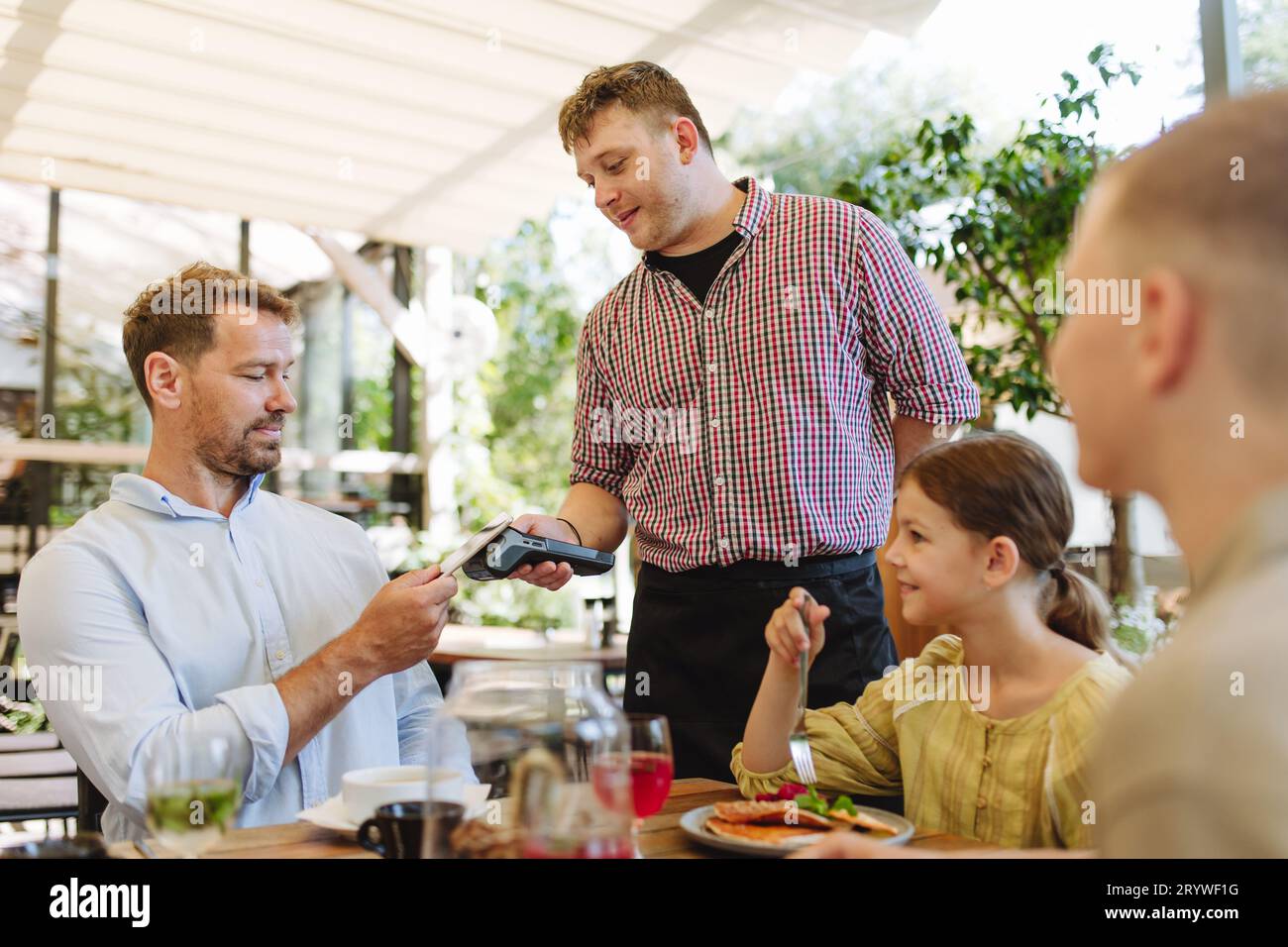 Man paying for lunch in a restaurant by card Stock Photo - Alamy