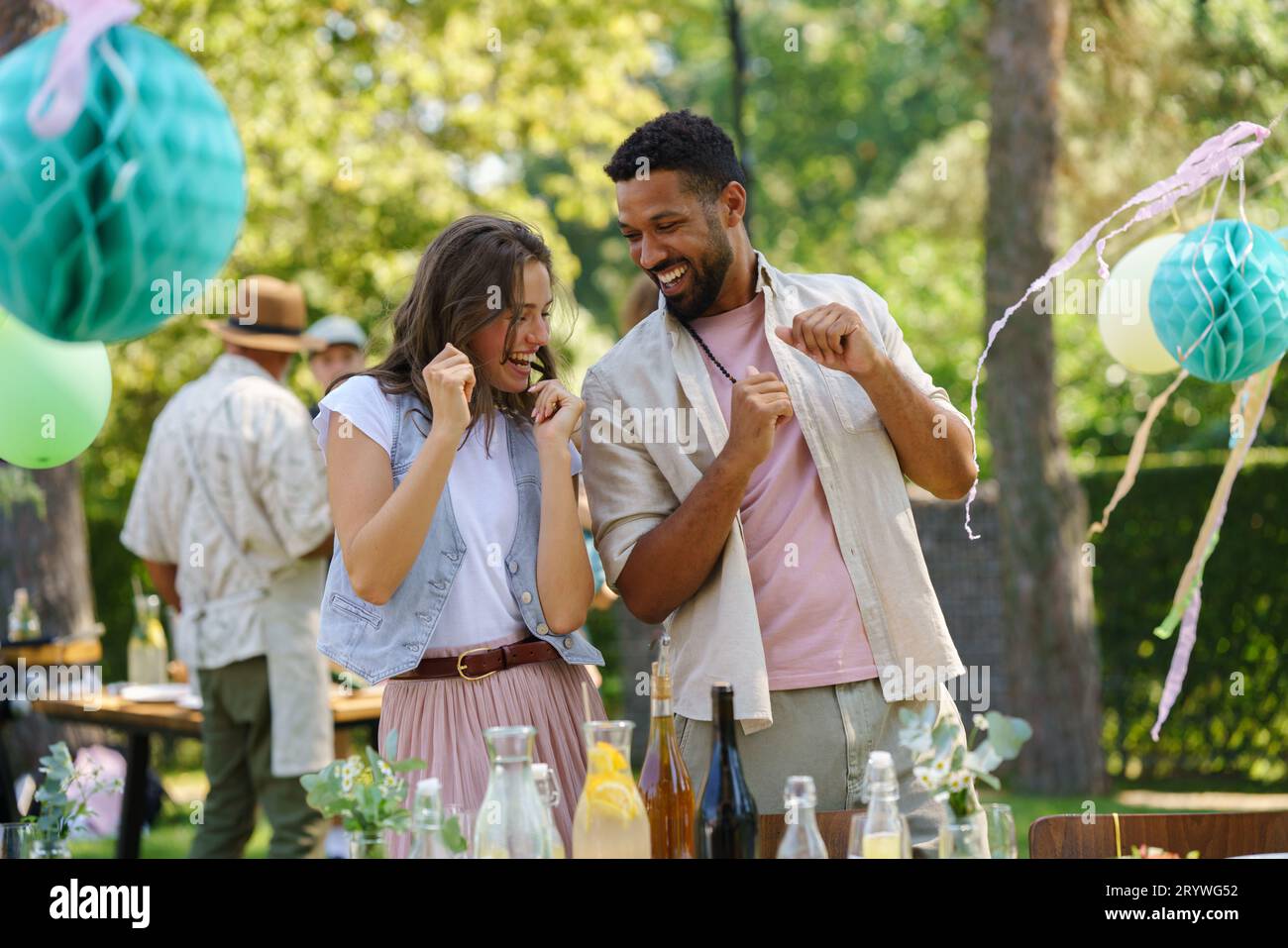 Friends talking and dancing at garden grill party Stock Photo - Alamy