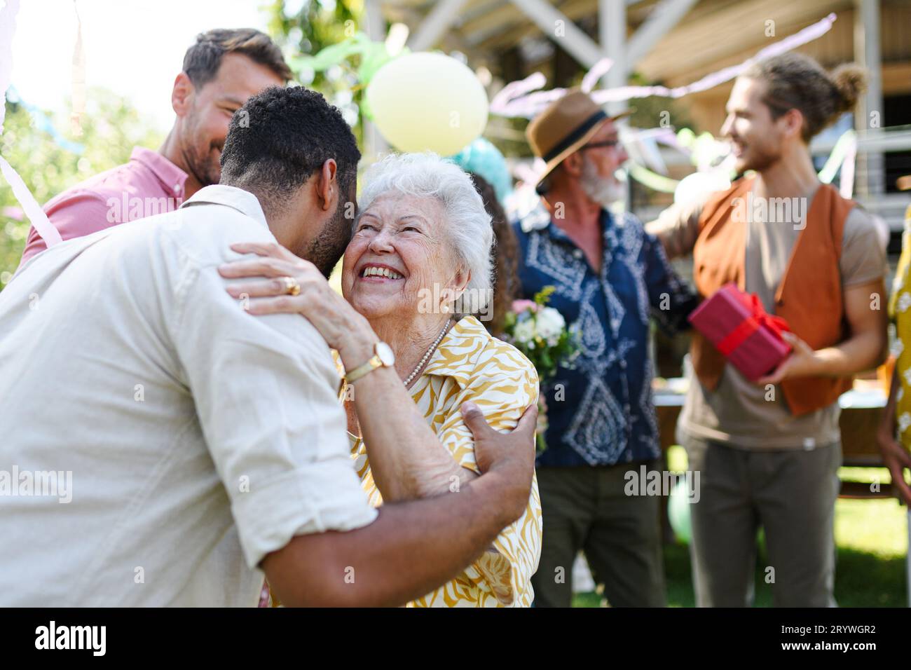 Beautiful senior birthday woman hugging man Stock Photo - Alamy