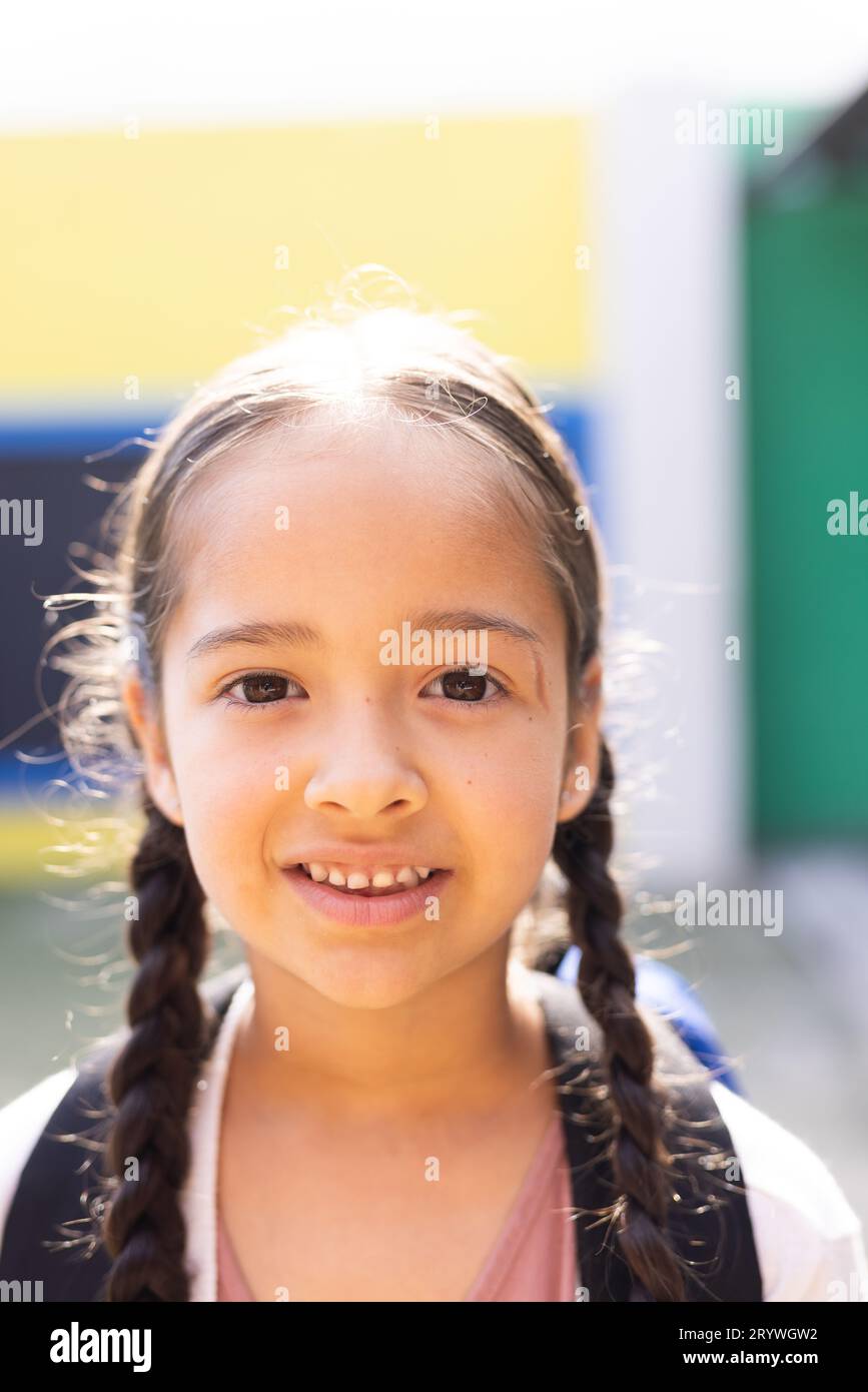 Vertical Portrait Of Smiling Cauasian Elementary Schoolgirl In School Playground Copy Space