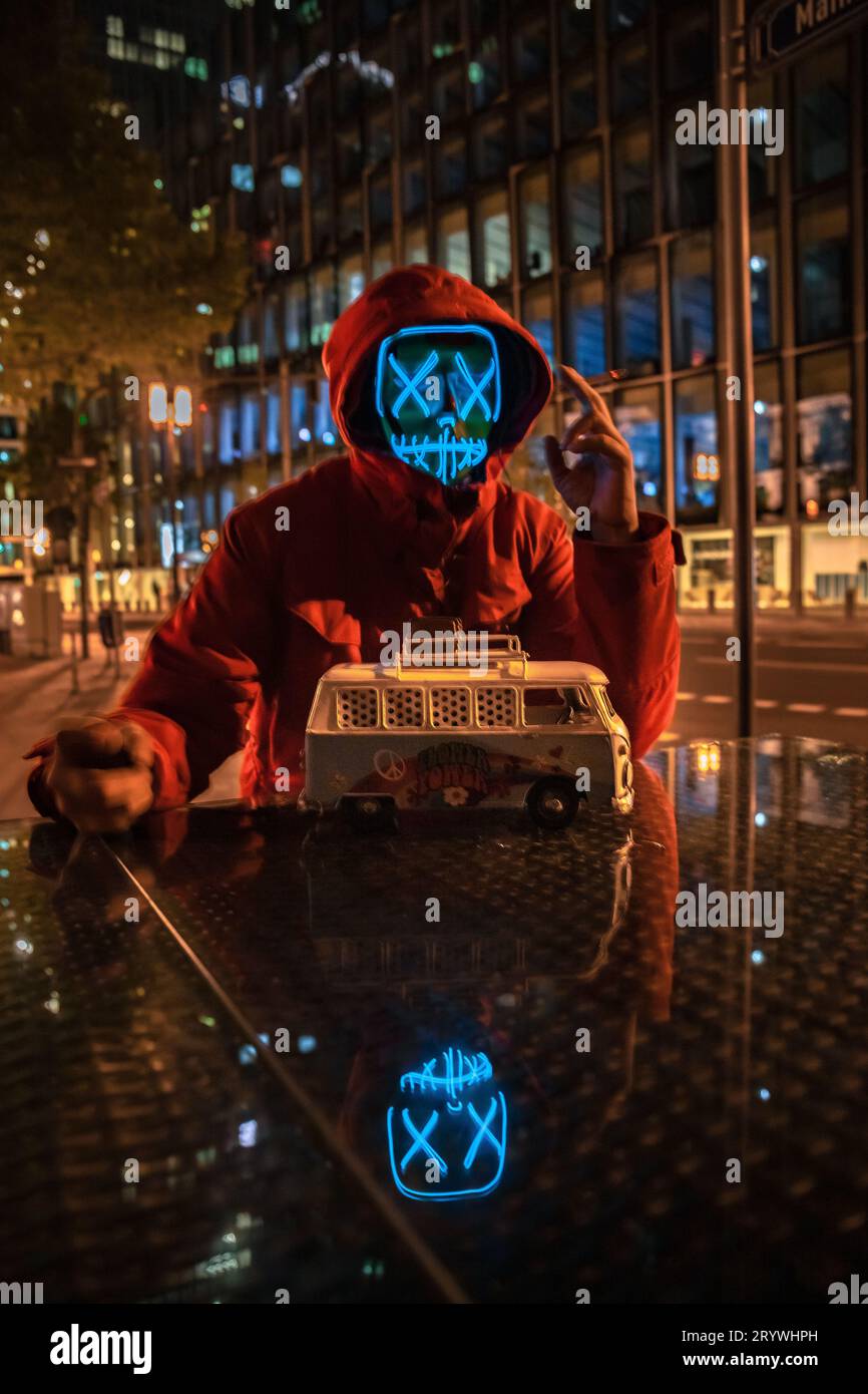 Night of the Purge: Person with LED Mask and Halloween Pumpkin in ...