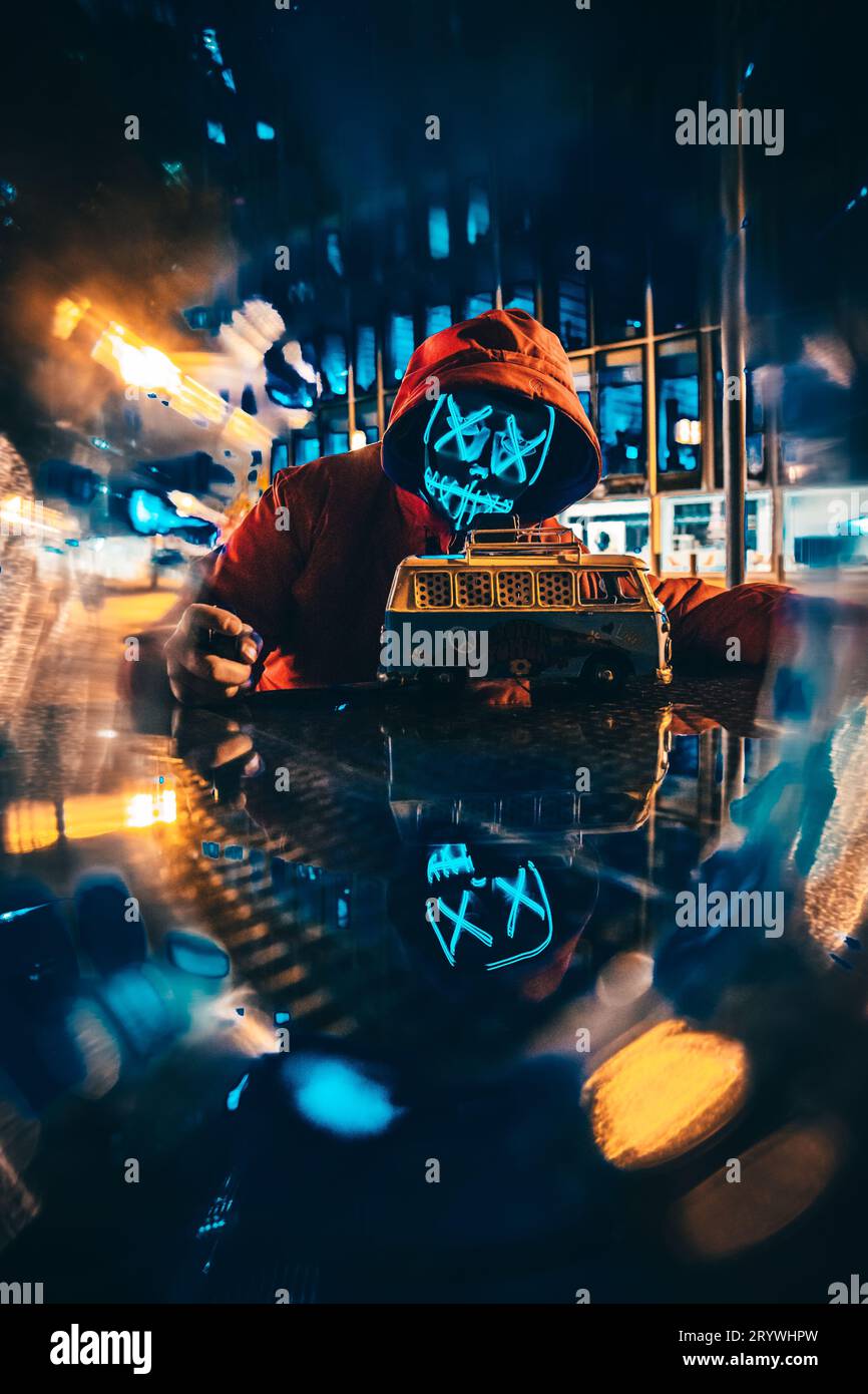 Night of the Purge: Person with LED Mask and Halloween Pumpkin in ...